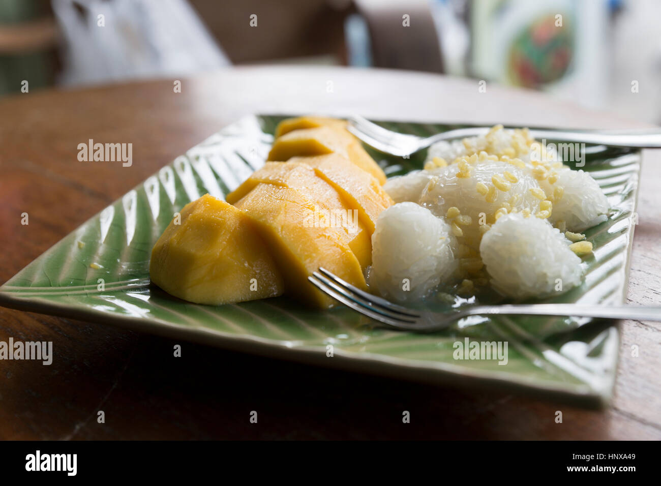 ripe mango with sticky rice topping with coconut milk and nut Stock ...