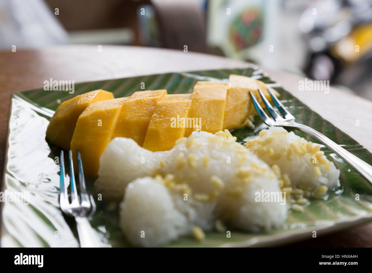 ripe mango with sticky rice topping with coconut milk and nut Stock ...