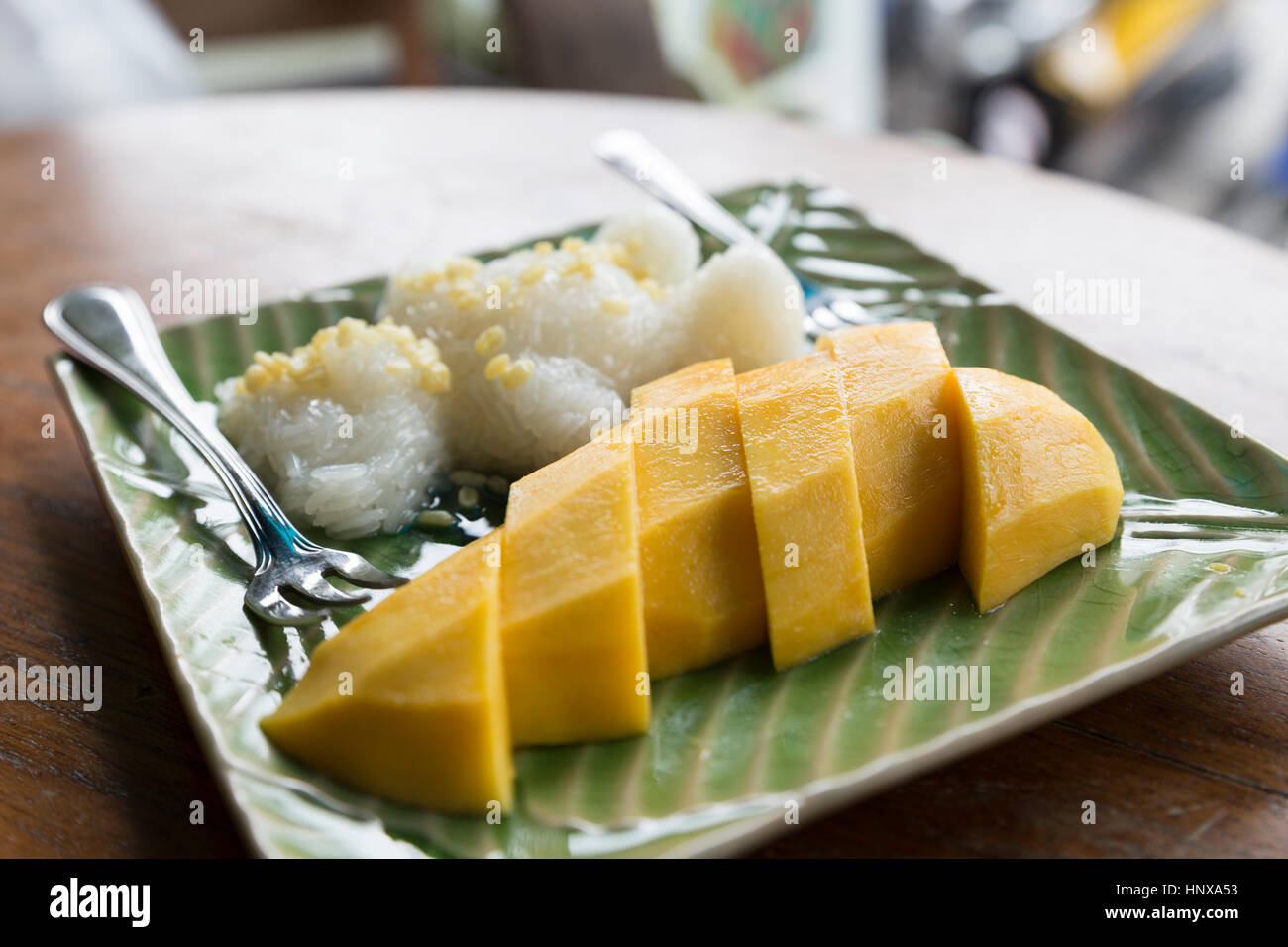 ripe mango with sticky rice topping with coconut milk and nut Stock ...