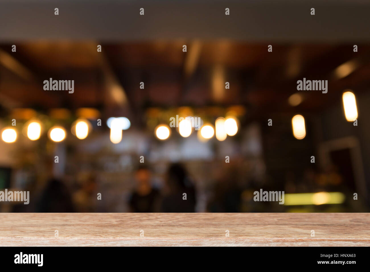 wood table with beverage counter at coffee shop restaurant (blur ...