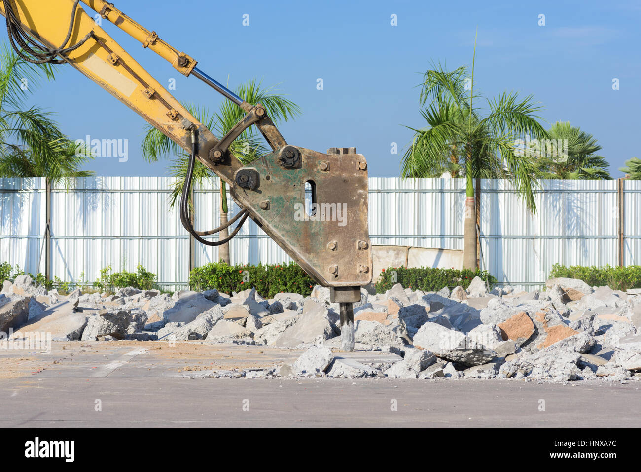 Excavator breaking concrete road surface with hydrohammer drill Stock ...