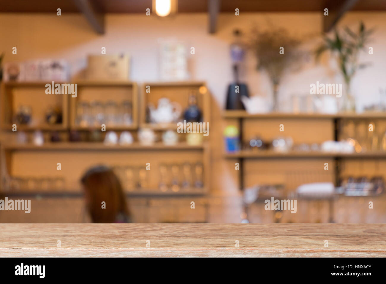 wood table with beverage counter at coffee shop restaurant (blur ...