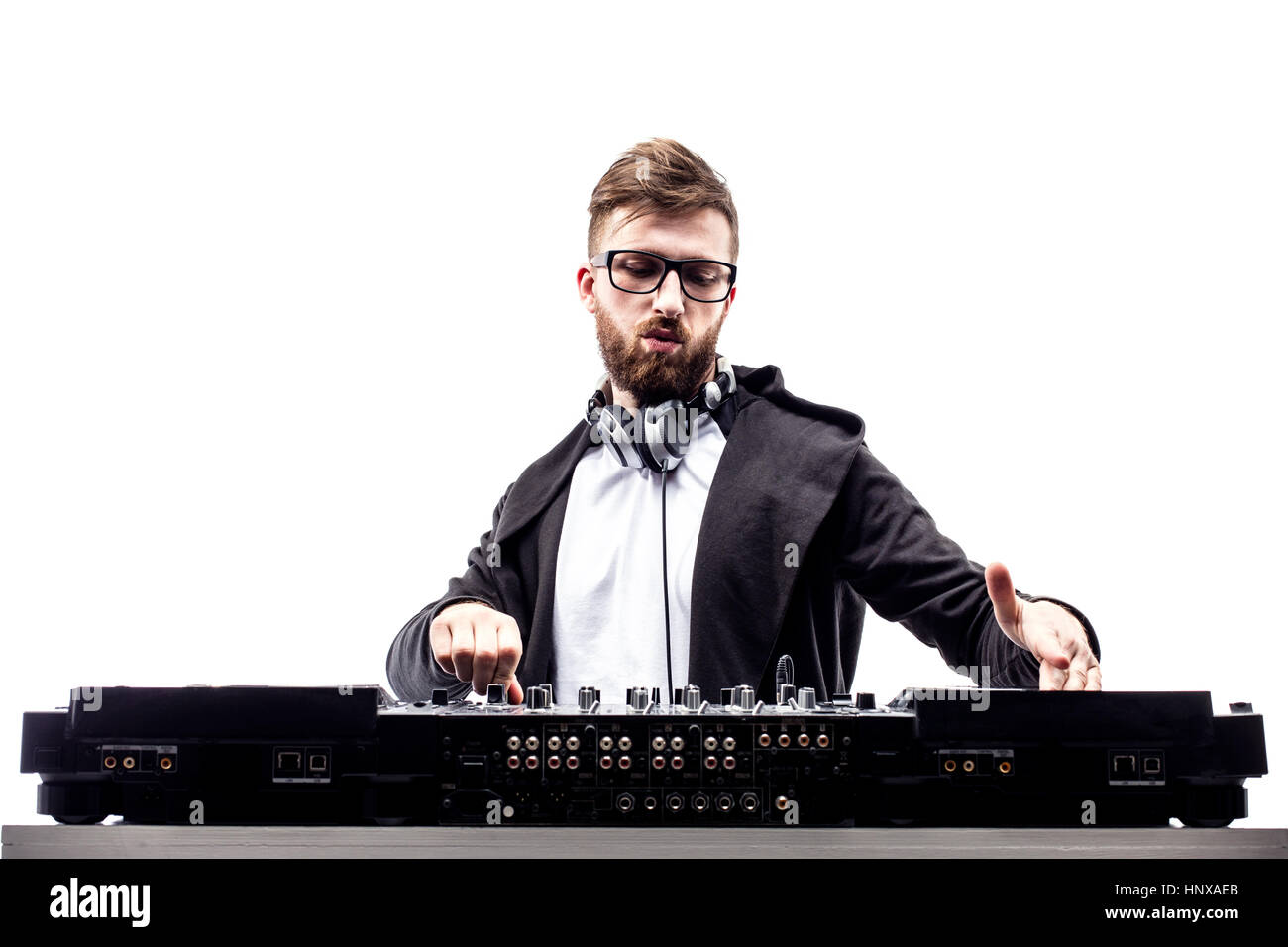 Trendy male dj posing against mixing console Stock Photo - Alamy