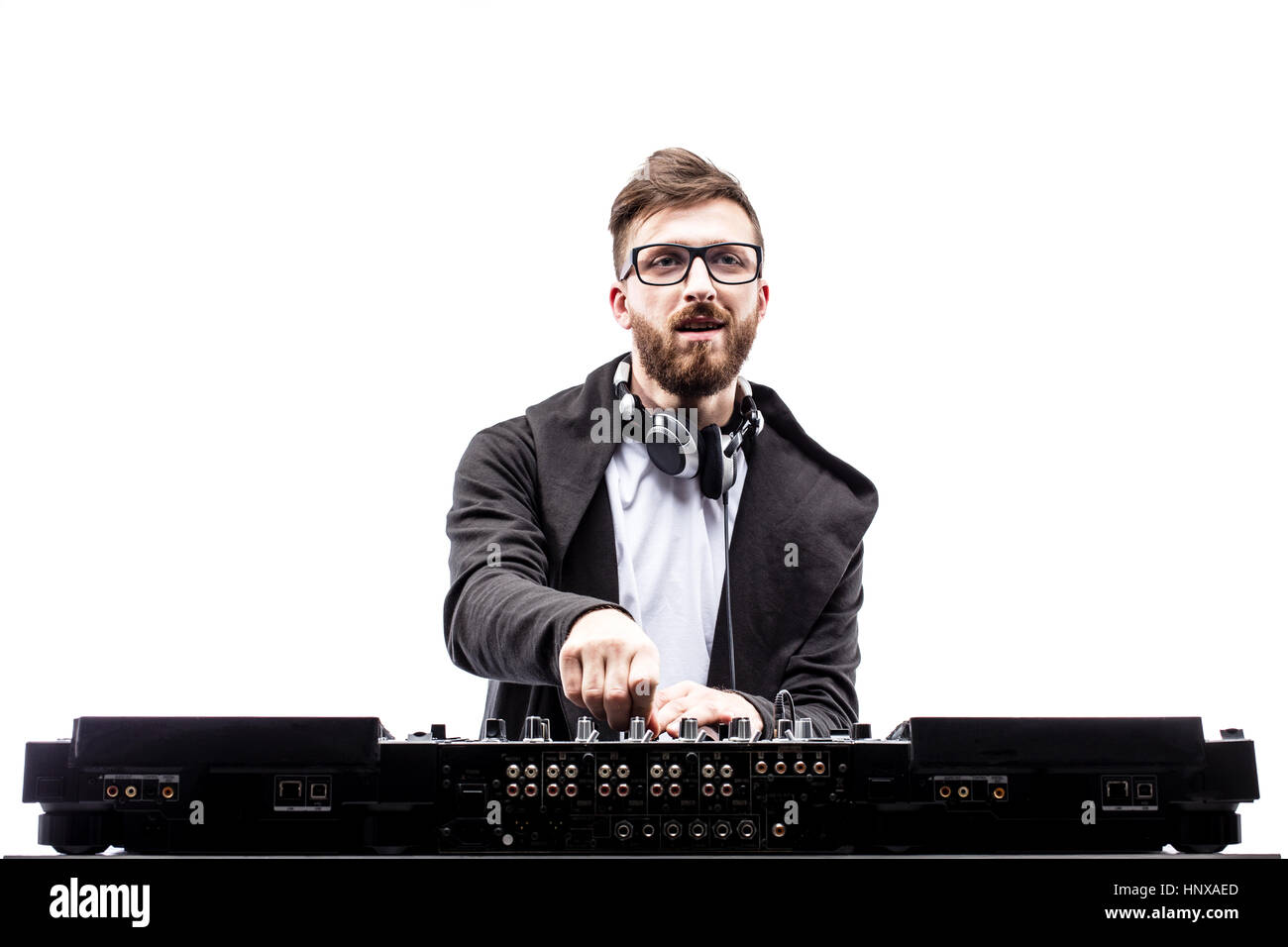 Trendy male dj posing against mixing console Stock Photo - Alamy
