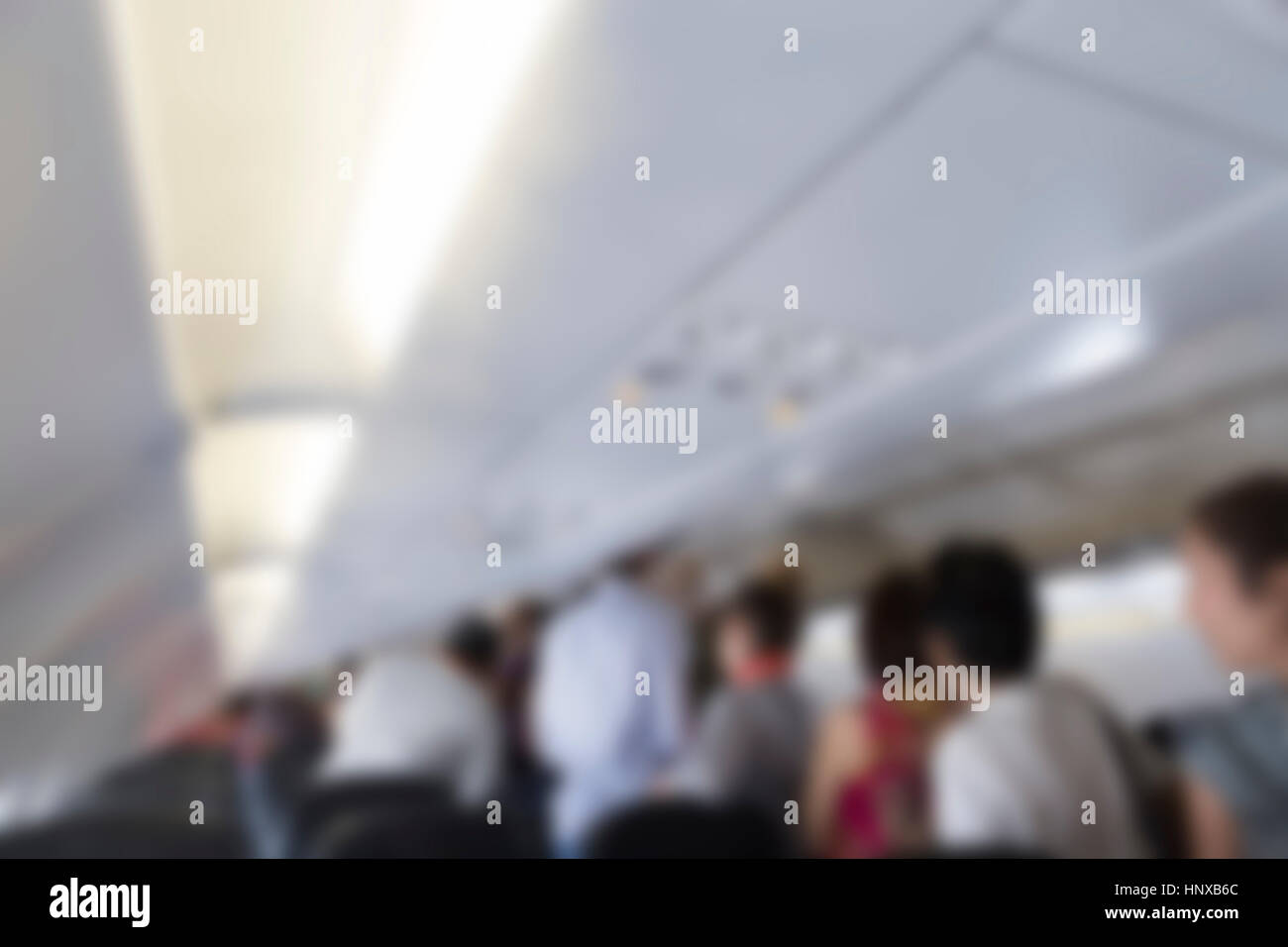 passenger walking in aisle in airplane cabin, blur background Stock ...