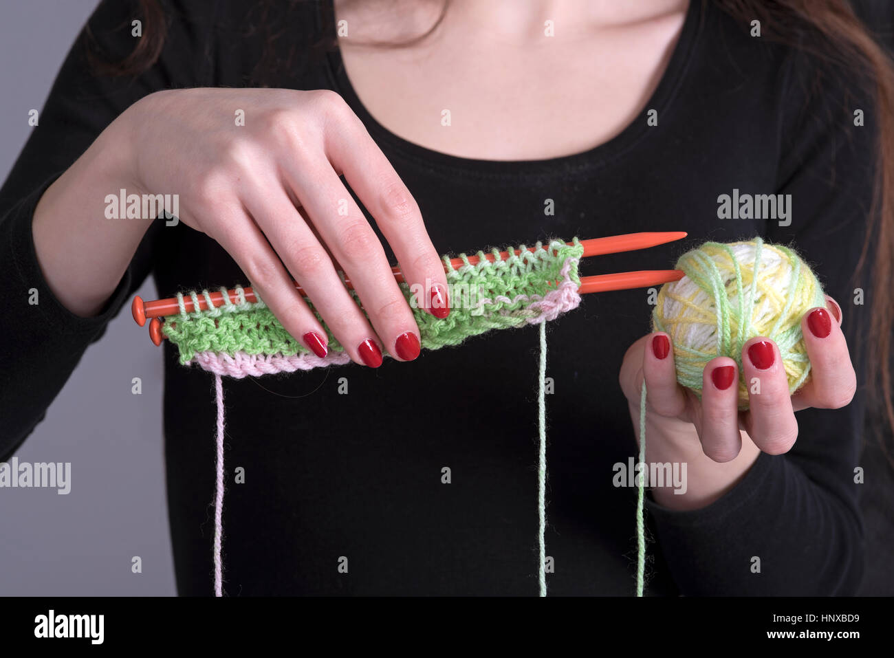A young person's hands with knitting wool and needles Stock Photo - Alamy