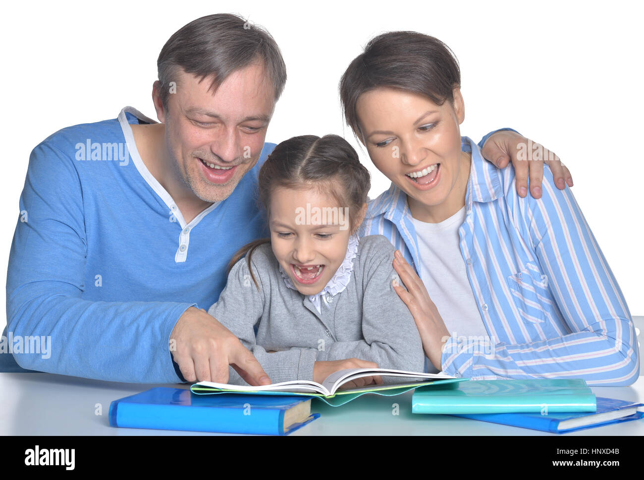 parents with daughter reading books Stock Photo - Alamy