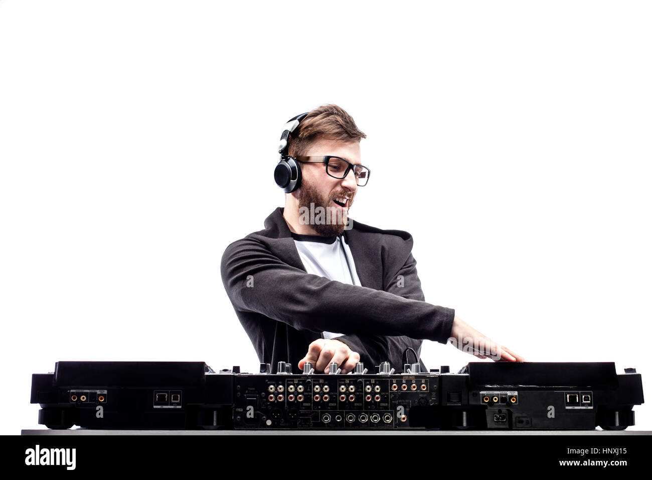 Trendy male dj posing against mixing console Stock Photo - Alamy