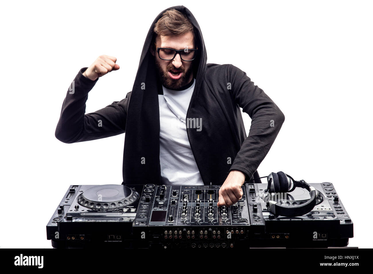 Trendy male dj posing against mixing console Stock Photo - Alamy