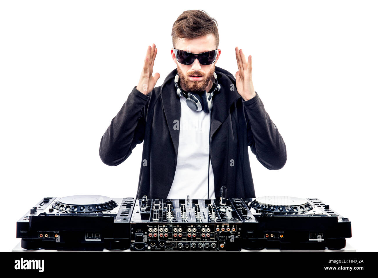 Trendy male dj posing against mixing console Stock Photo - Alamy