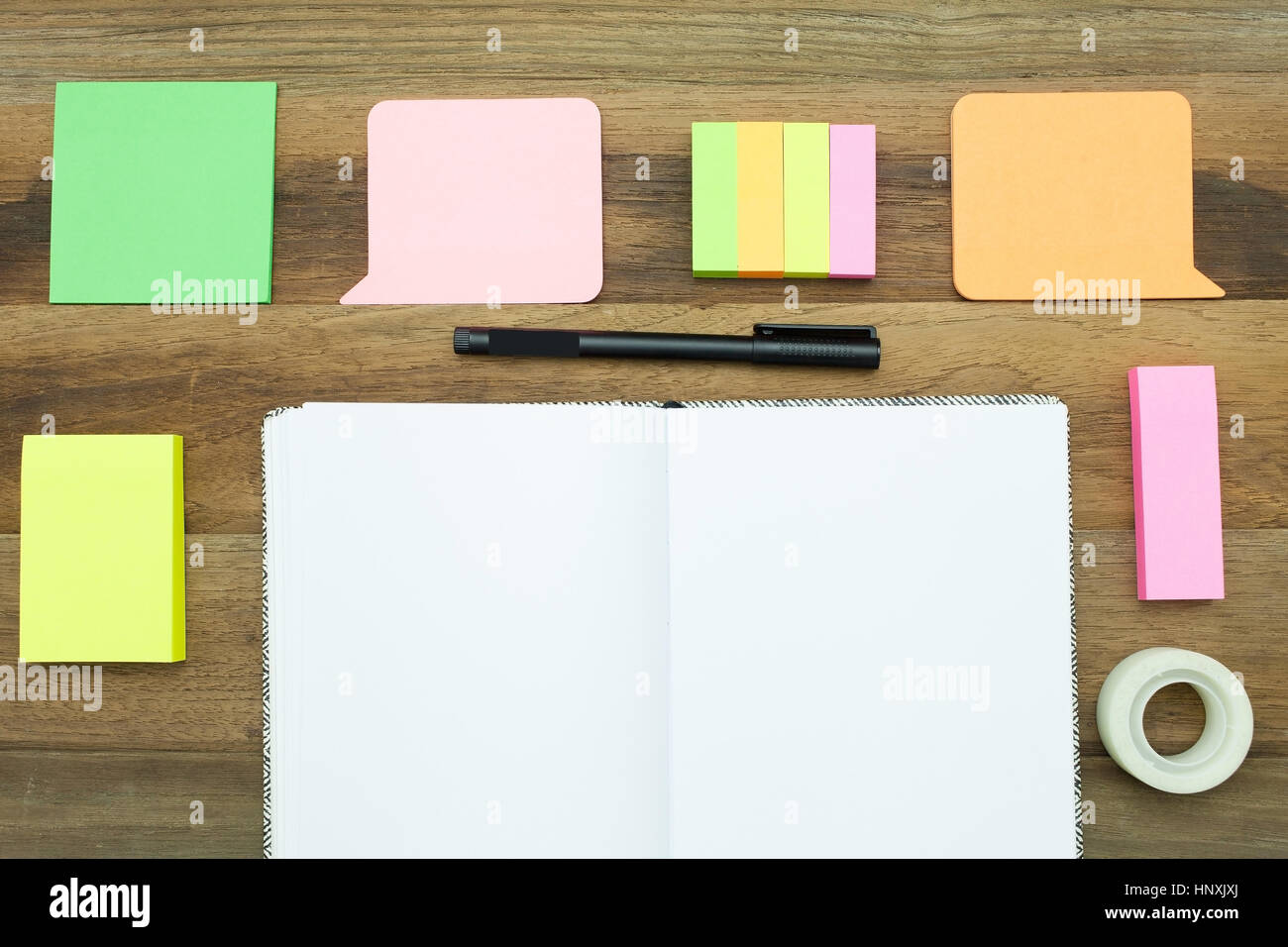 A colorful blank post it paper around a notice board with wooden ...