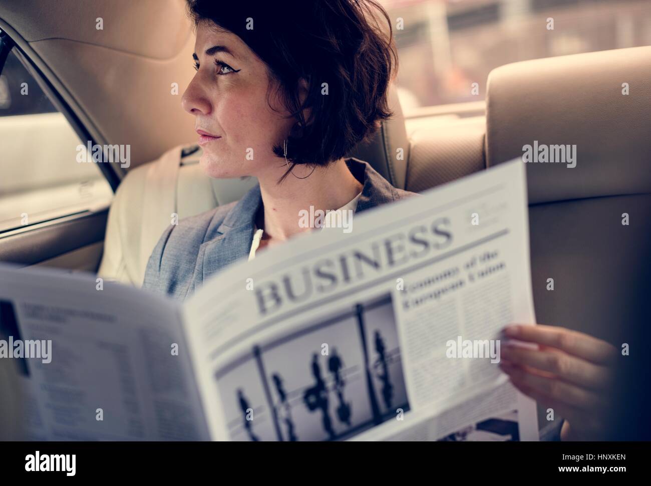 Businesswoman Reading Newspaper Car Inside Stock Photo - Alamy