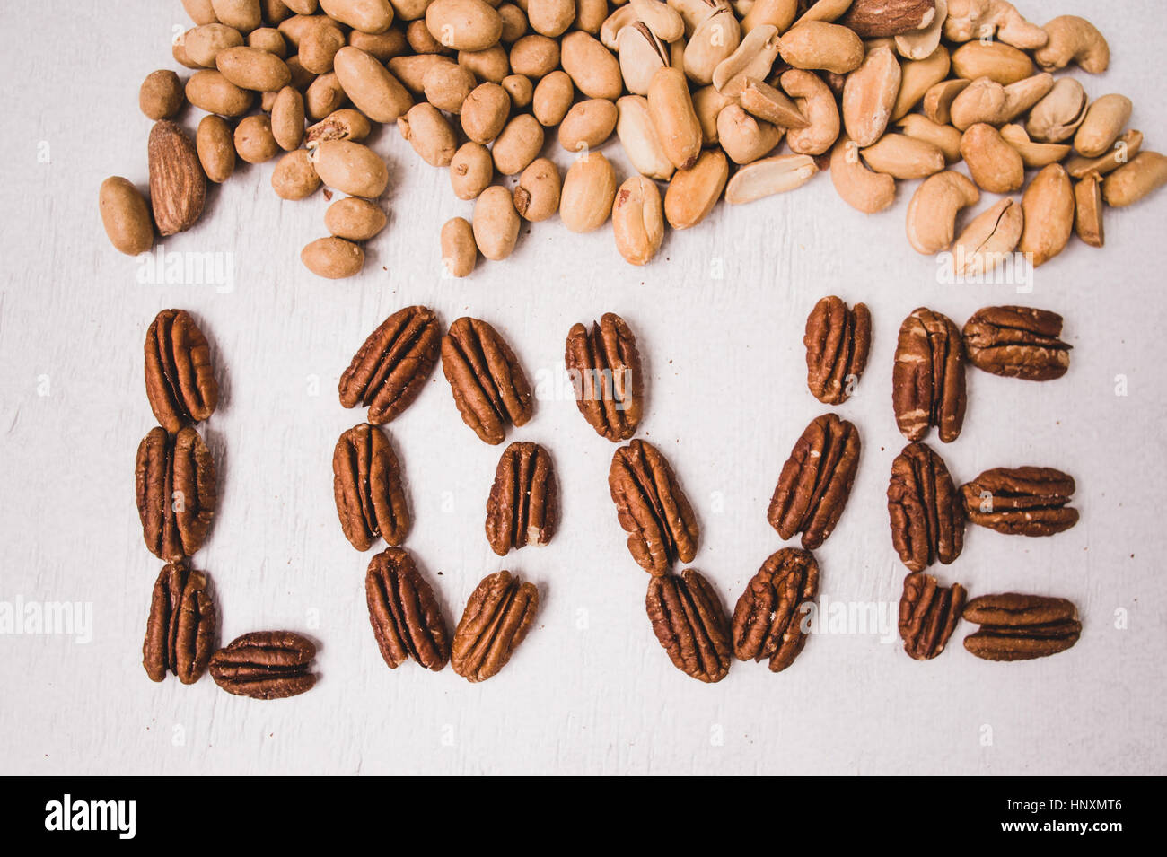 Nuts mixed, for backgrounds or textures, love letters Stock Photo - Alamy