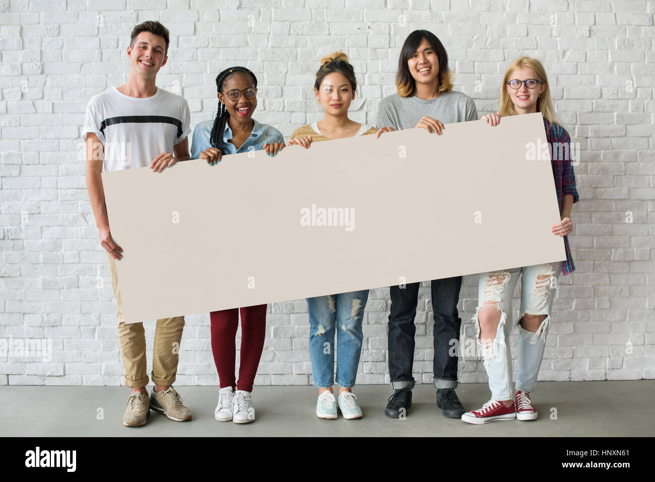 Group of Friends Holding Blank Banner Stock Photo - Alamy