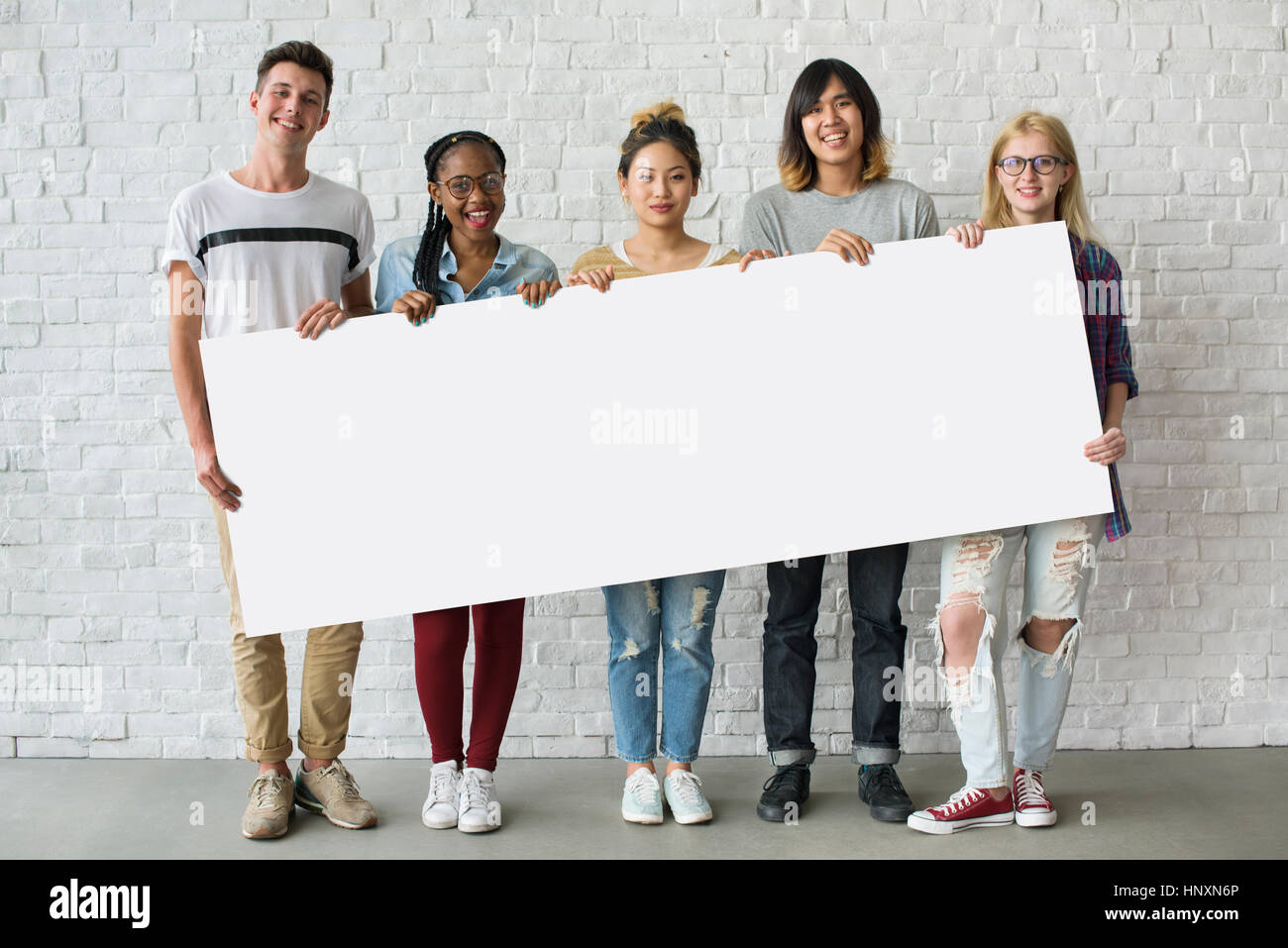 Group of Friends Holding Blank Banner Stock Photo - Alamy