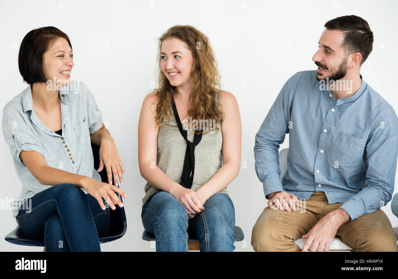Group of cheerful people sitting in a row Stock Photo - Alamy