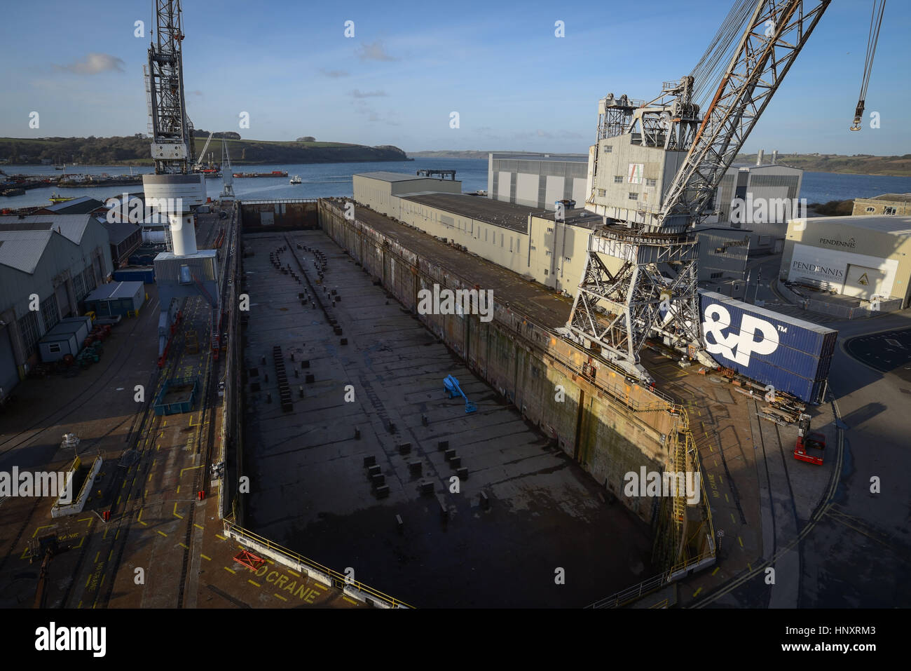 Large cranes next to a empty dry dock and Falmouth Dock in Cornwall ...