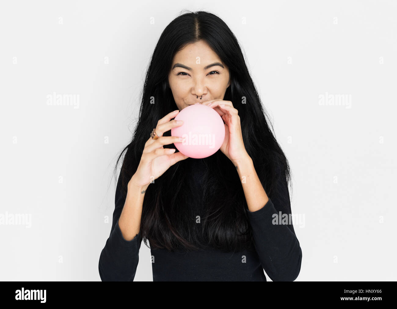 Asian woman blowing balloon hi-res stock photography and images - Alamy