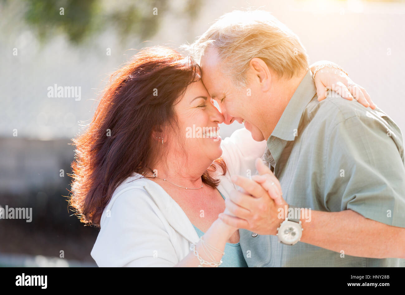 Happy Middle Aged Couple Enjoy A Romantic Slow Dance Outside Stock ...