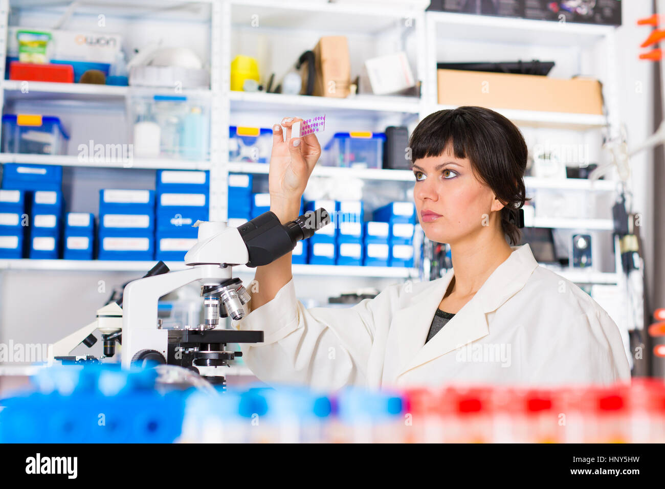 Young woman in biological laboratory. Attractive young female scientis ...