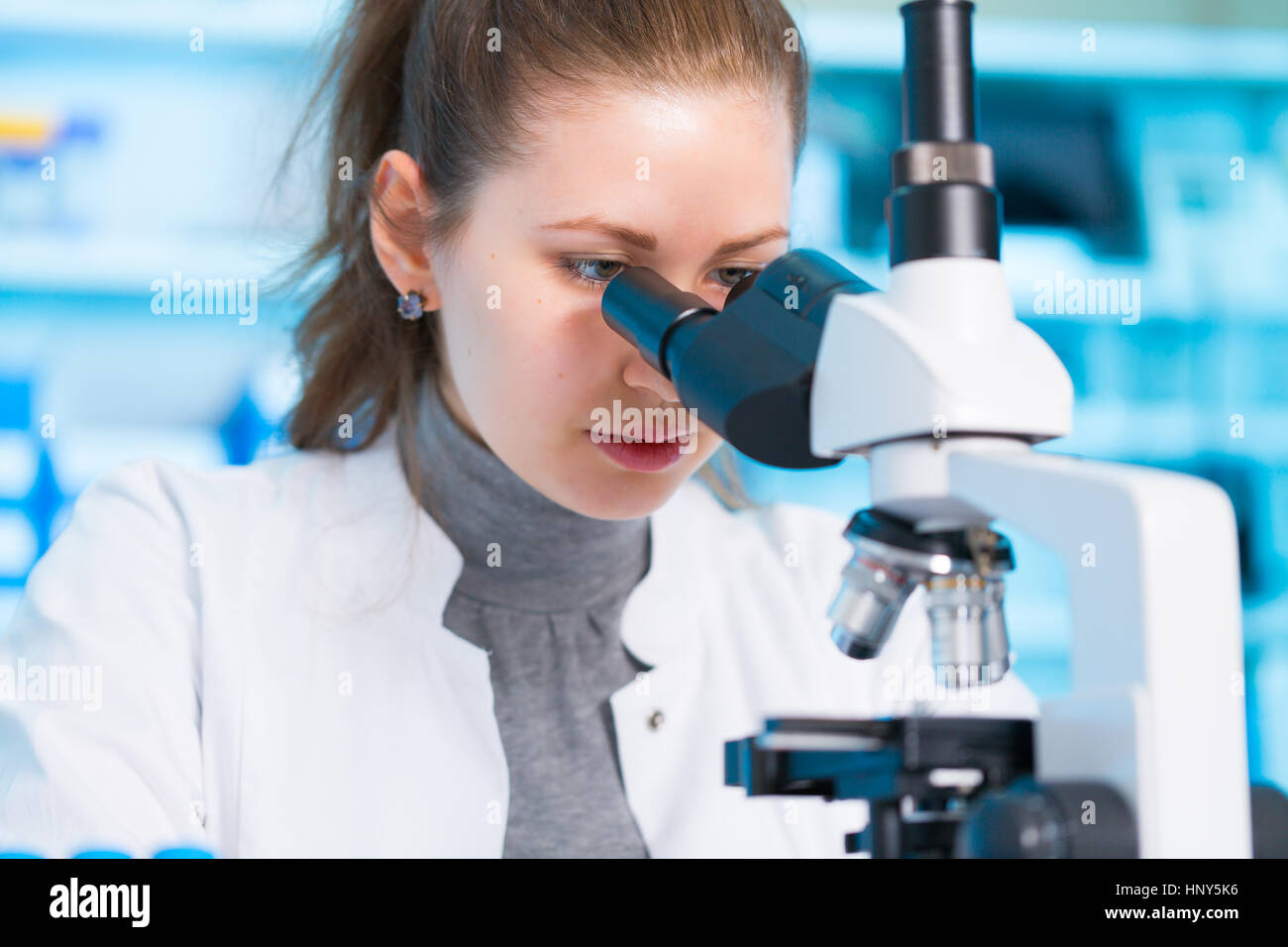 Young woman in biological laboratory. Attractive young female scientis ...