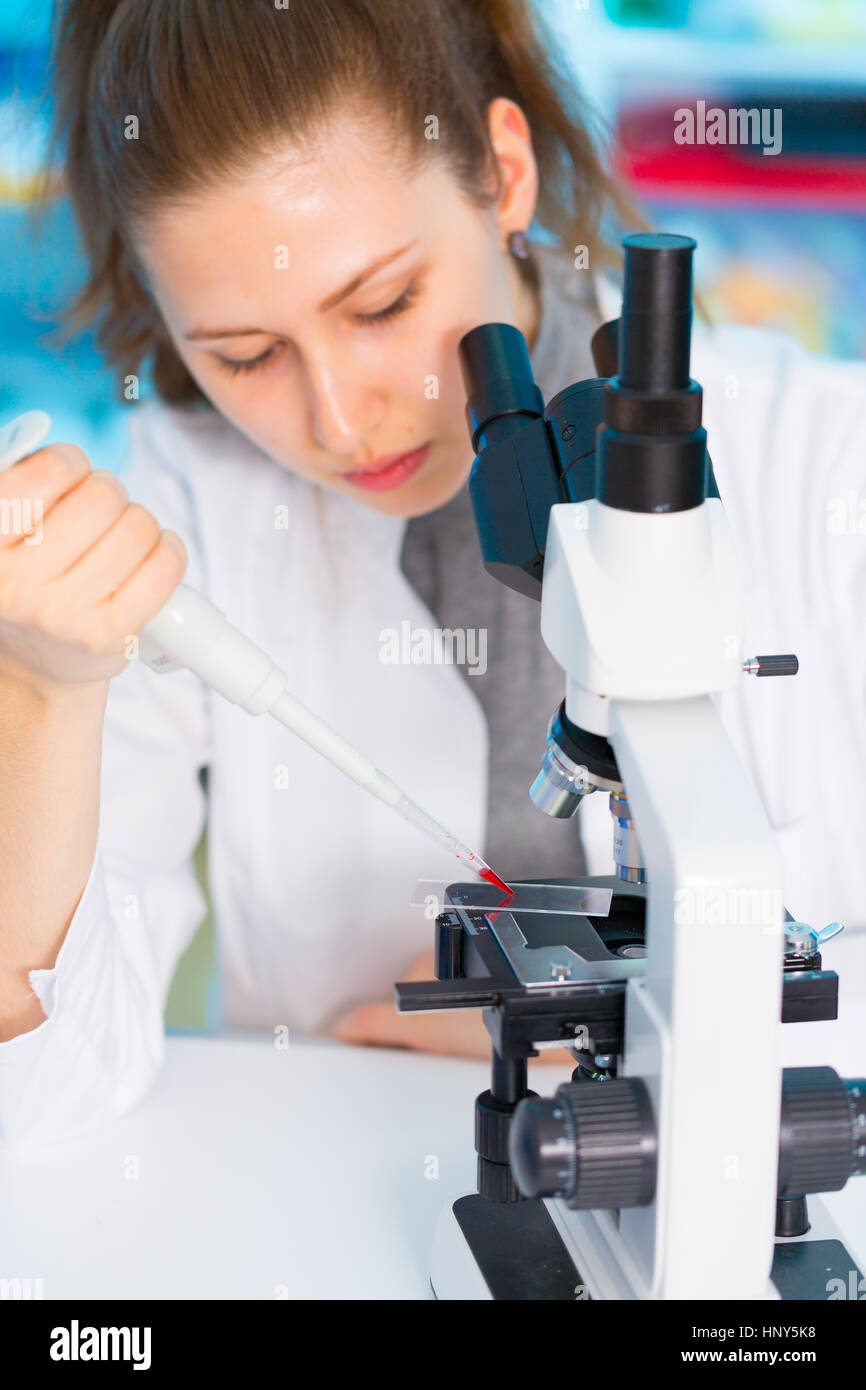 Young woman in biological laboratory. Attractive young female scientis ...