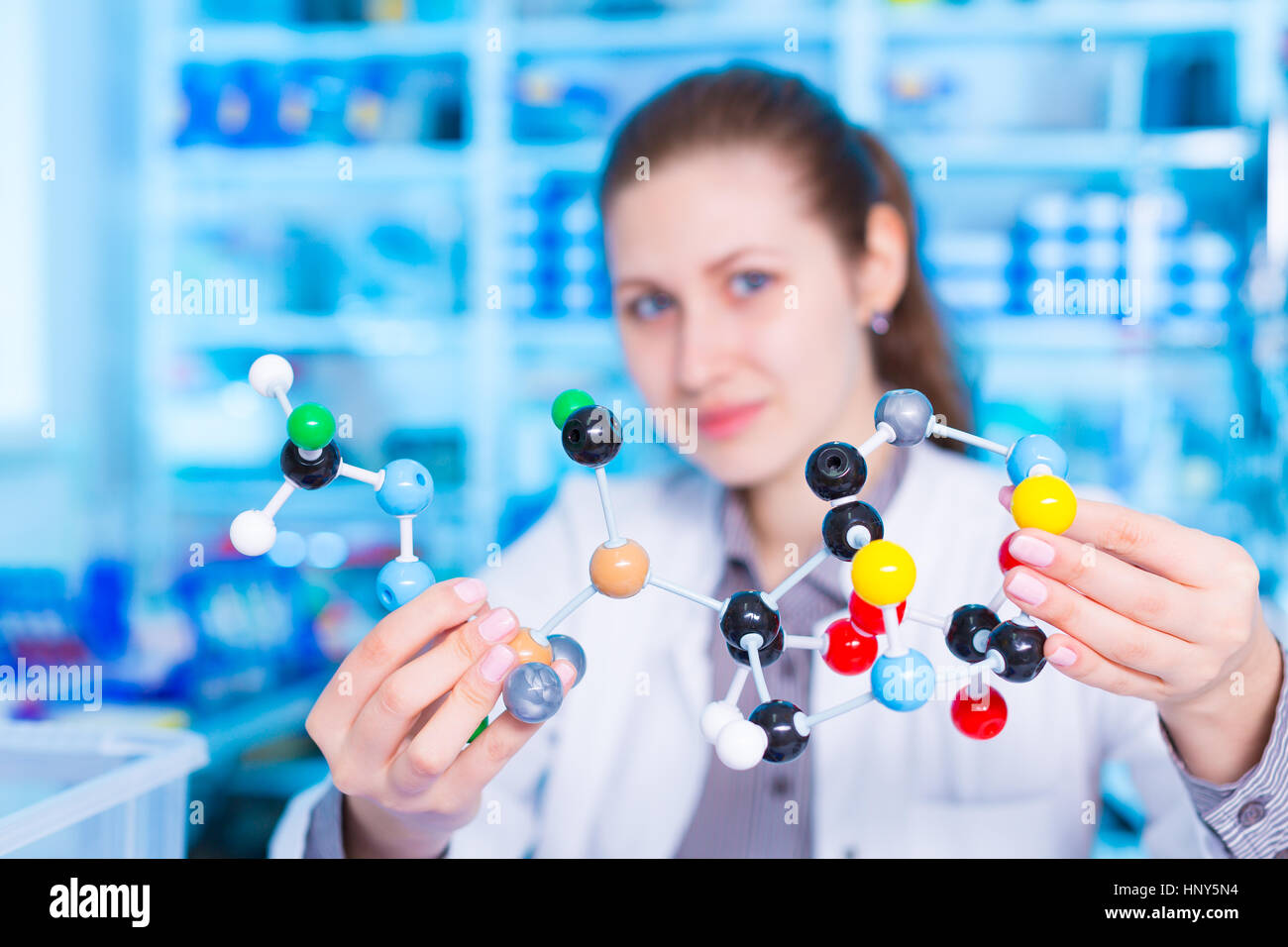 Woman scientist holding model of molecule or crystal lattice. scientist ...