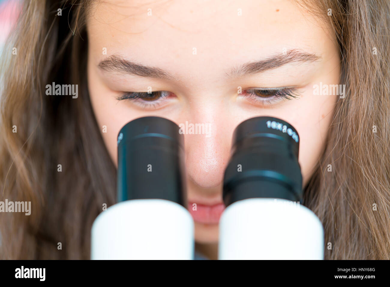 girl in biological class research with microscope Stock Photo - Alamy