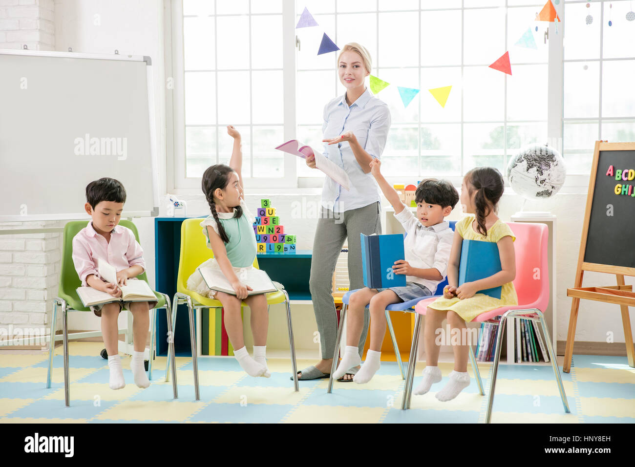 Class at kindergarten with foreign teacher Stock Photo - Alamy