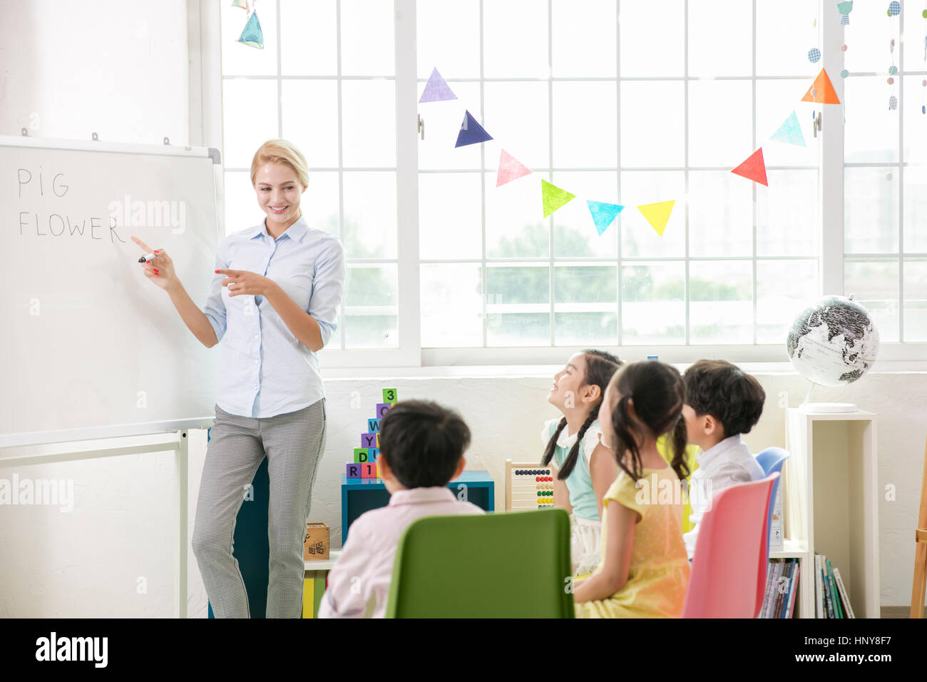 Class at kindergarten with foreign teacher Stock Photo - Alamy