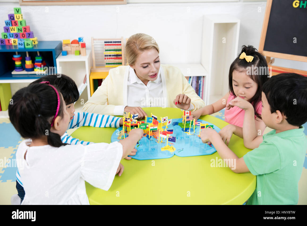 Kindergarten class with foreign teacher Stock Photo - Alamy