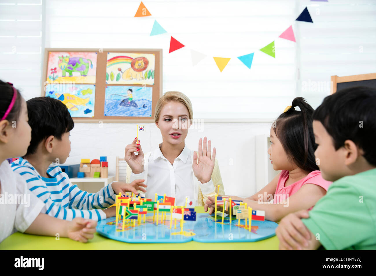 Kindergarten class with foreign teacher Stock Photo - Alamy
