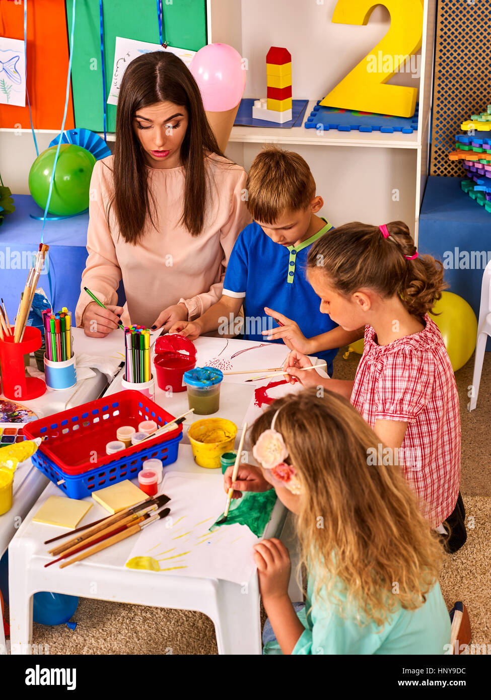 Children painting and drawing together . Craft lesson in primary school ...
