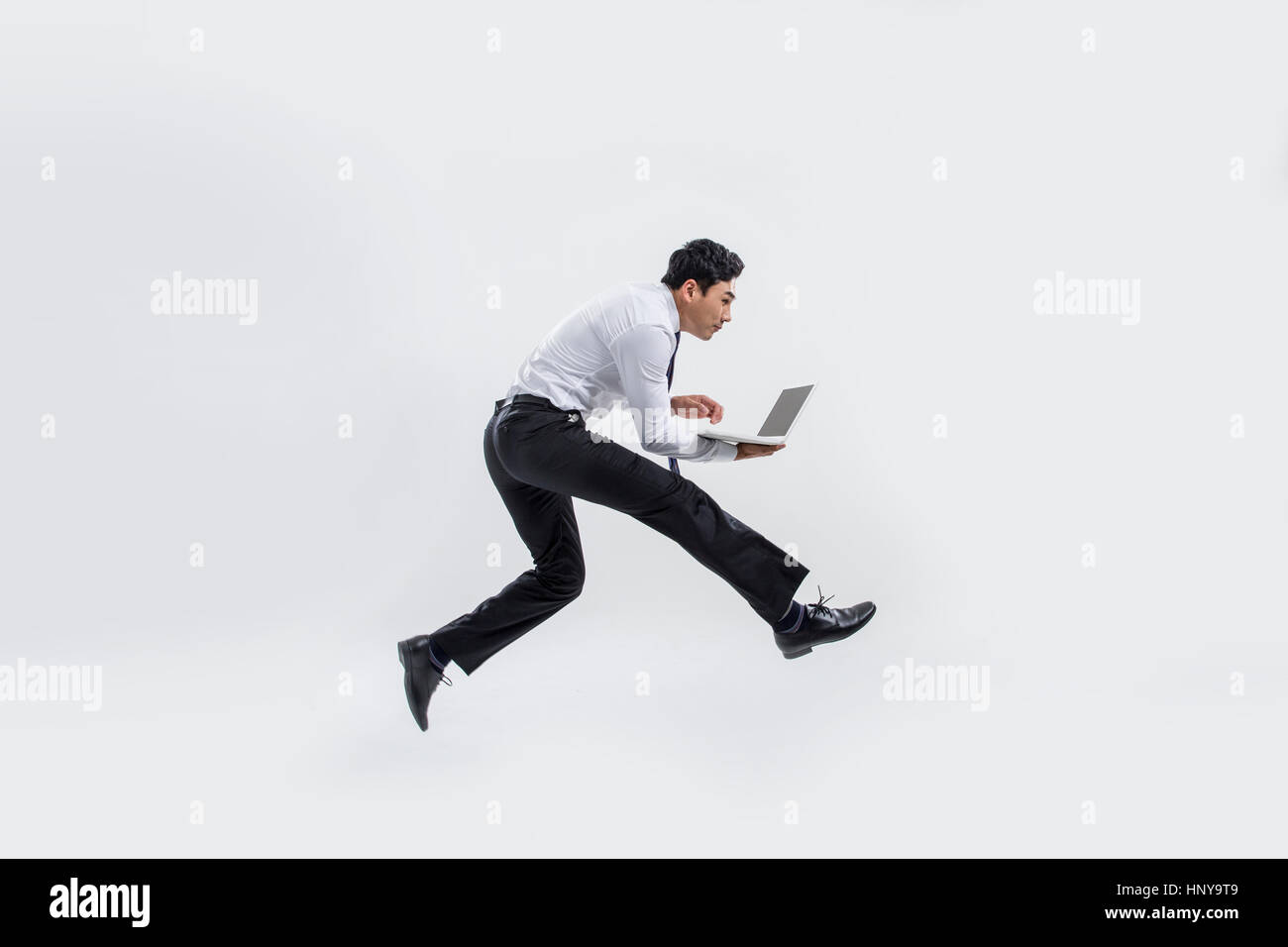 Man suit jumping laptop hi-res stock photography and images - Alamy