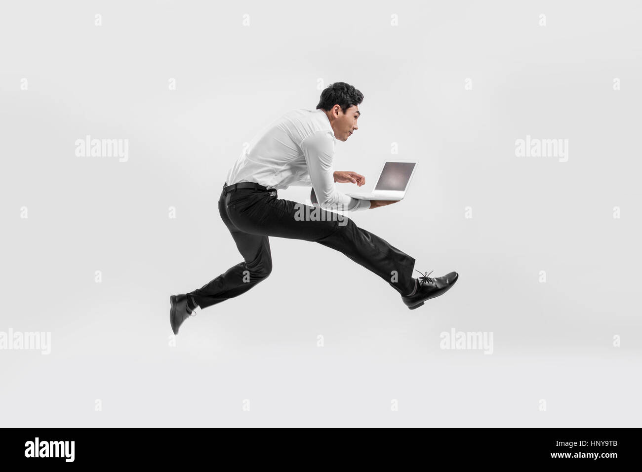 Man suit jumping laptop hi-res stock photography and images - Alamy