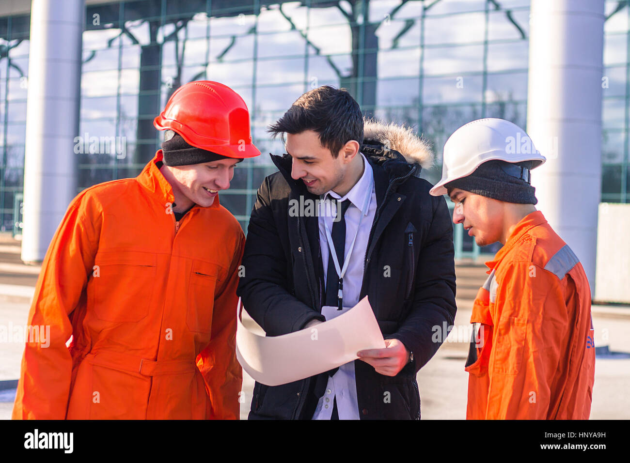 boss or Chief instructs young team of young engineers with a ...