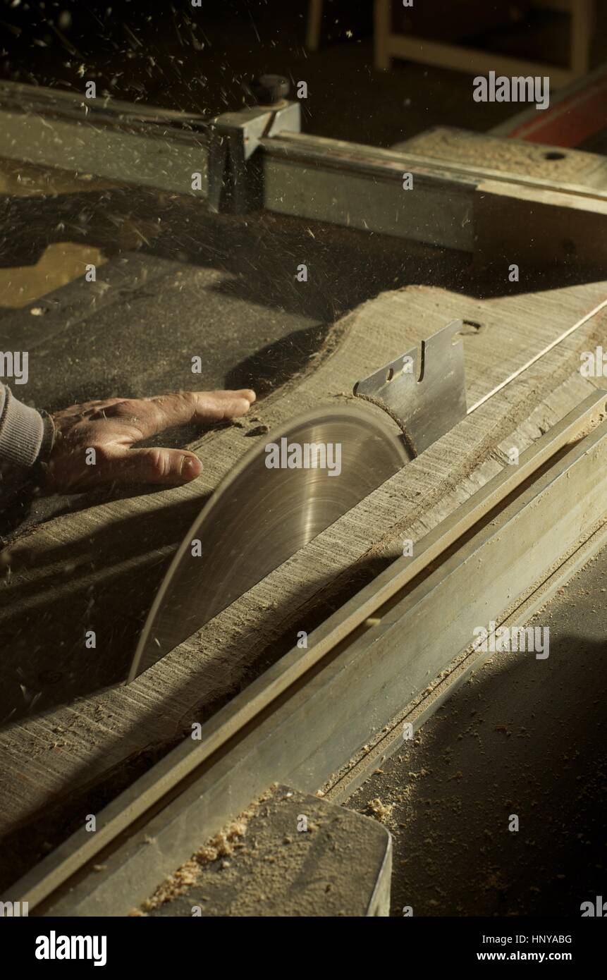 Carpenter cutting wood with circular bench saw Stock Photo - Alamy