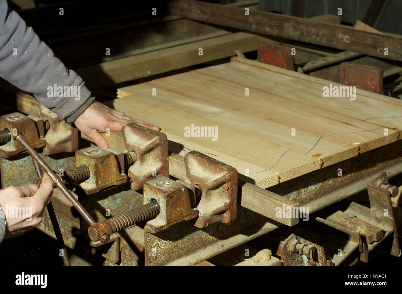 Carpenter placing wood in a press for gluing Stock Photo - Alamy