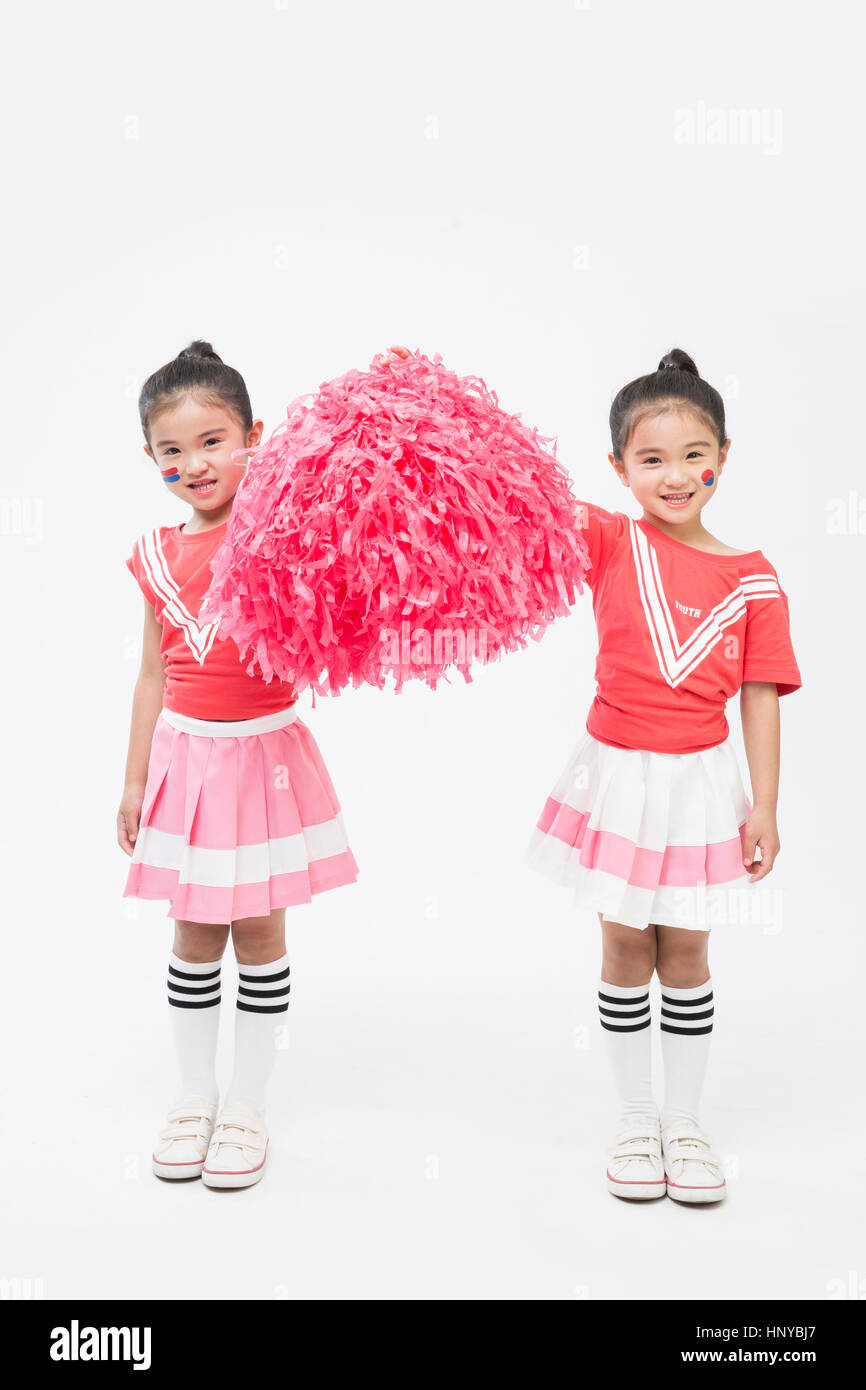 Smiling twin cheerleader girls Stock Photo - Alamy