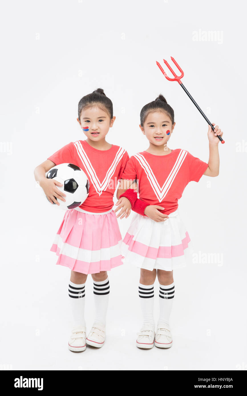 Smiling twin cheerleader girls Stock Photo - Alamy