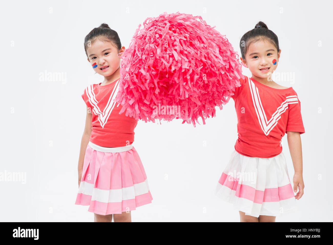 Smiling twin cheerleader girls Stock Photo - Alamy