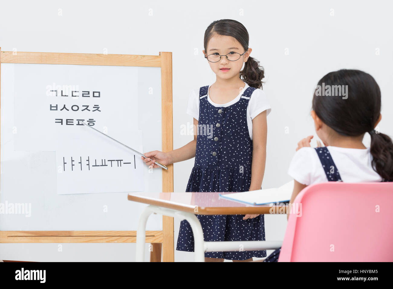 Twin girls learning Korean alphabet Stock Photo - Alamy