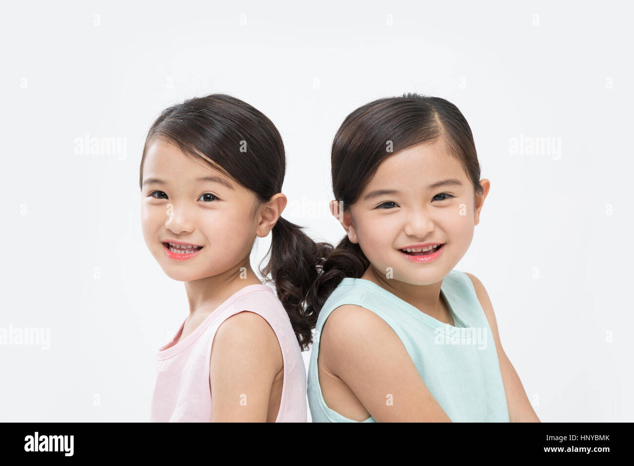 Smiling twin girls Stock Photo - Alamy