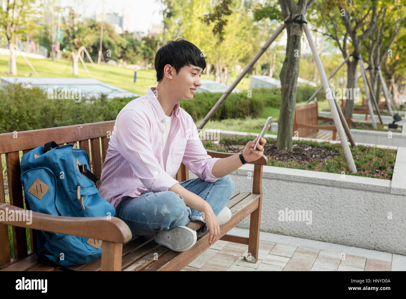 Male college student in casual clothes on bench Stock Photo - Alamy