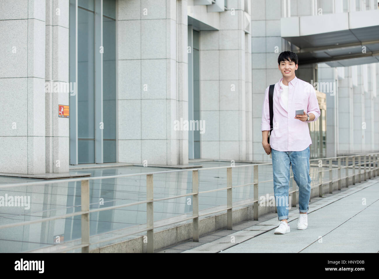 Male student walking campus hi-res stock photography and images - Alamy