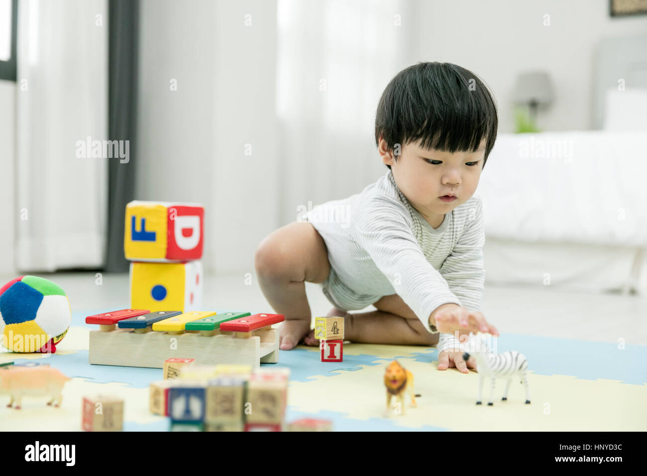 Baby boy playing with toys Stock Photo - Alamy