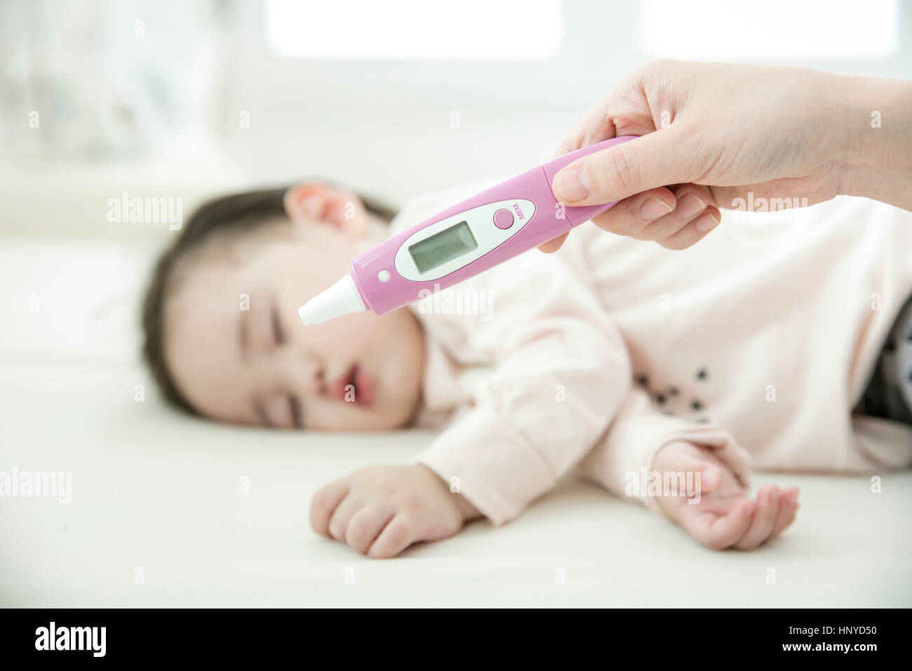 Hand taking baby's temperature Stock Photo - Alamy