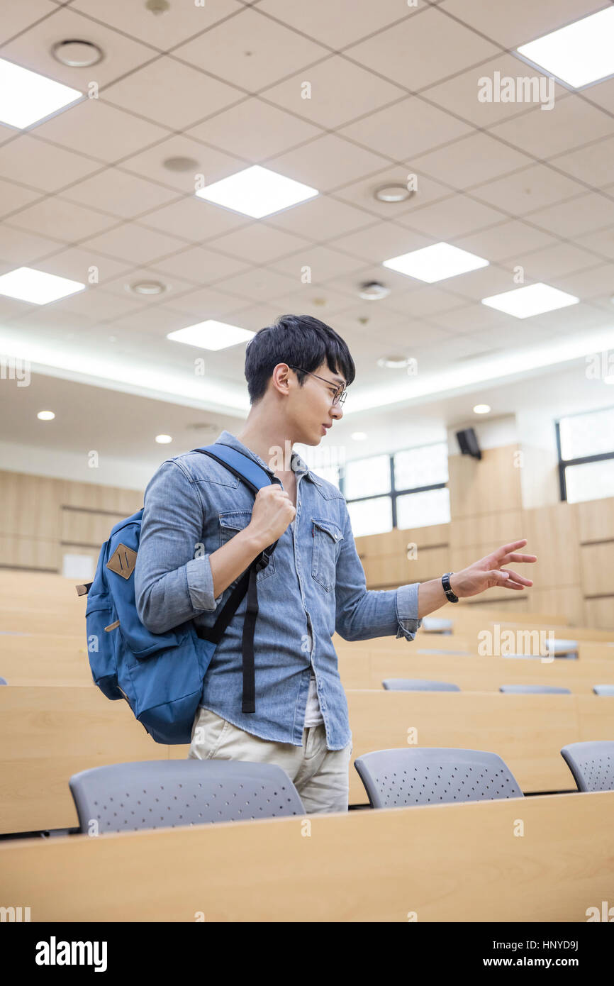 Side view of male college student Stock Photo - Alamy