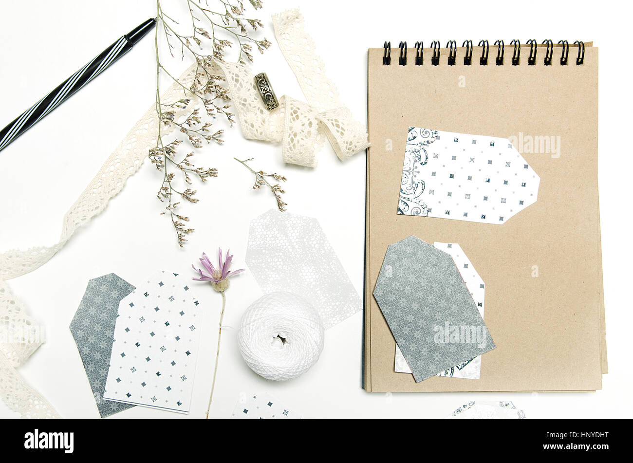 Label stickers on craft paper notebook and pressed flowers Stock Photo ...