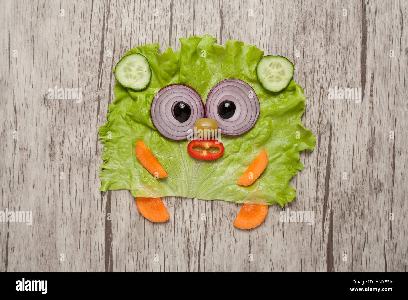 Bear made of green vegetables on wooden plank Stock Photo - Alamy